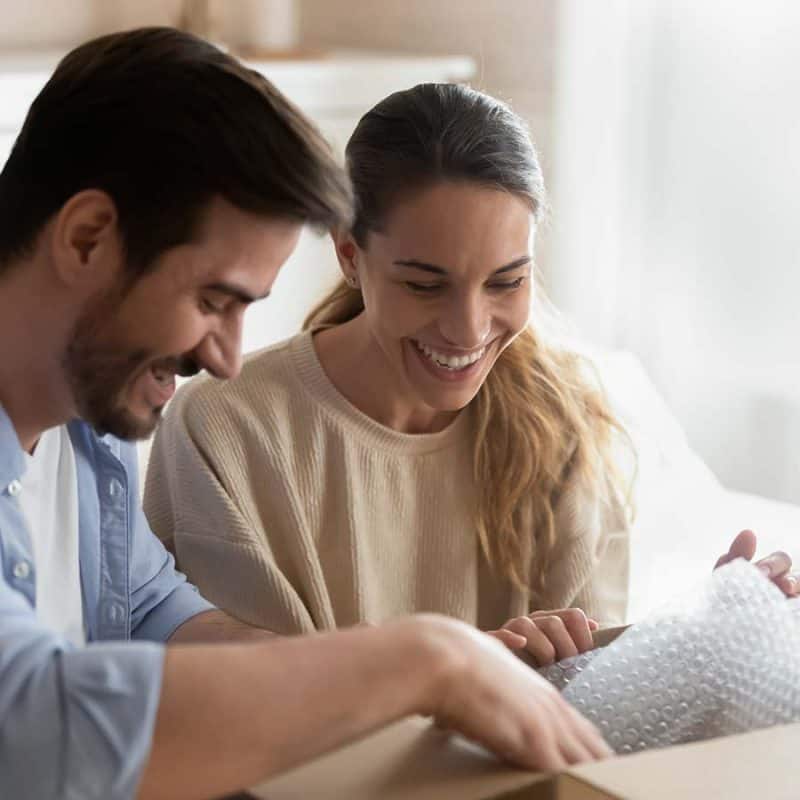 Couple opening a package together - Nationwide Credit Corp